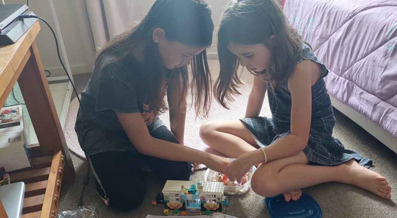 Ella and friend building LEGO | Kidspot